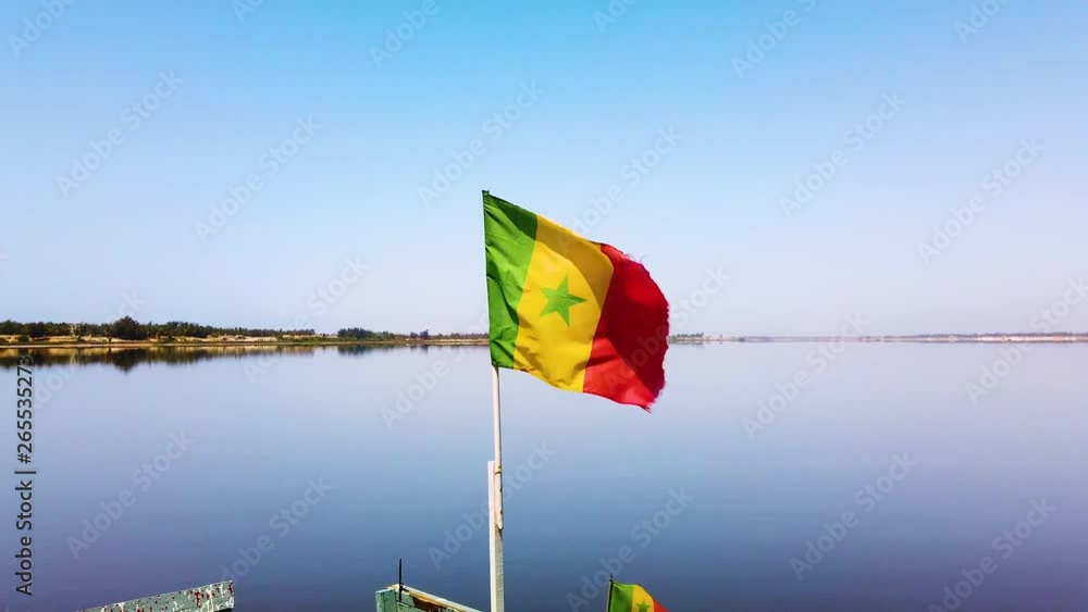 4K video of Senegal flag waving on blue sky and pink salt lake in ...