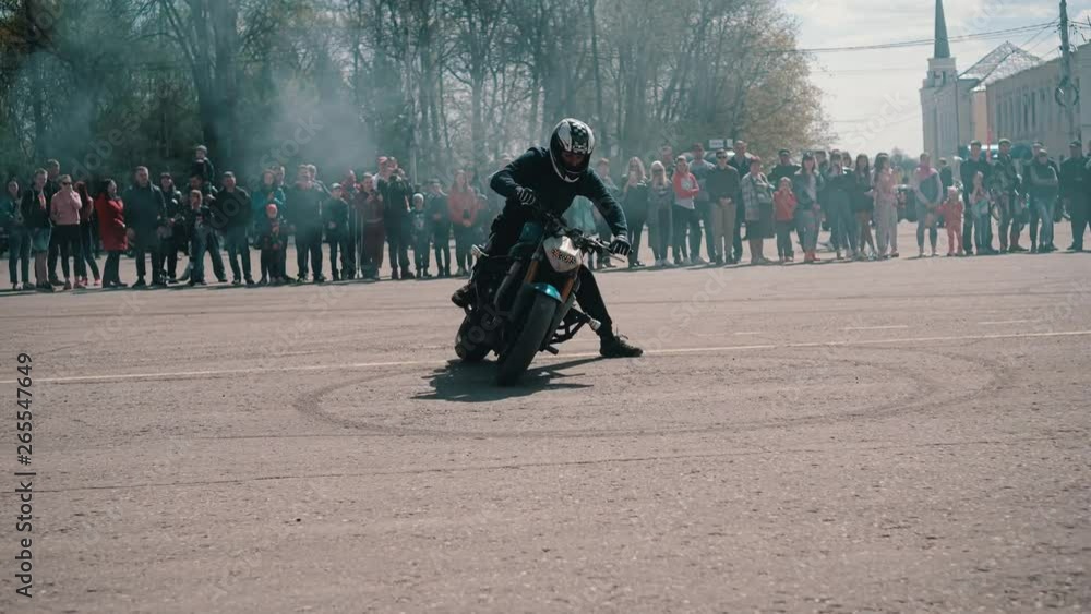 Motorcyclist very spectacular drifting and spinning in a circle leaving ...