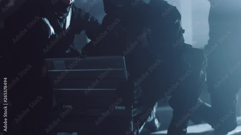 Masked Team of Armed SWAT Police Officers with Rifles are in Dark ...