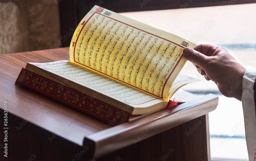 Prayer leader worship with Quran in a mosque, close up, indoor ...