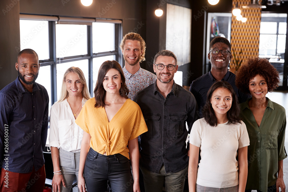 Portrait of a creative business team standing and smiling to camera in ...