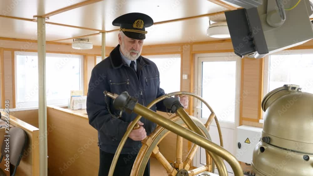 Video „Elderly grey-haired captain of the ship in peaked cap at the ...