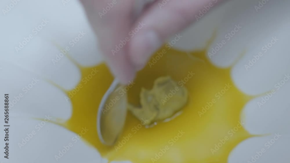 An original serving of food. Mustard lying on the plate while chef's ...
