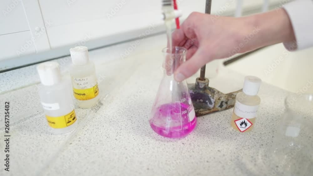 Chemical reaction titration experiment turns liquid from purple to ...