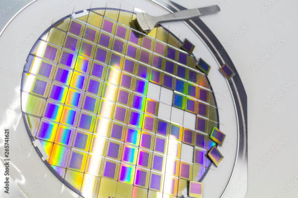 Silicon wafer with microchips, fixed in a holder with a steel frame on ...