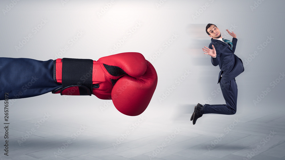 Giant hand gives a kick to a small employee businessman Stock Photo ...