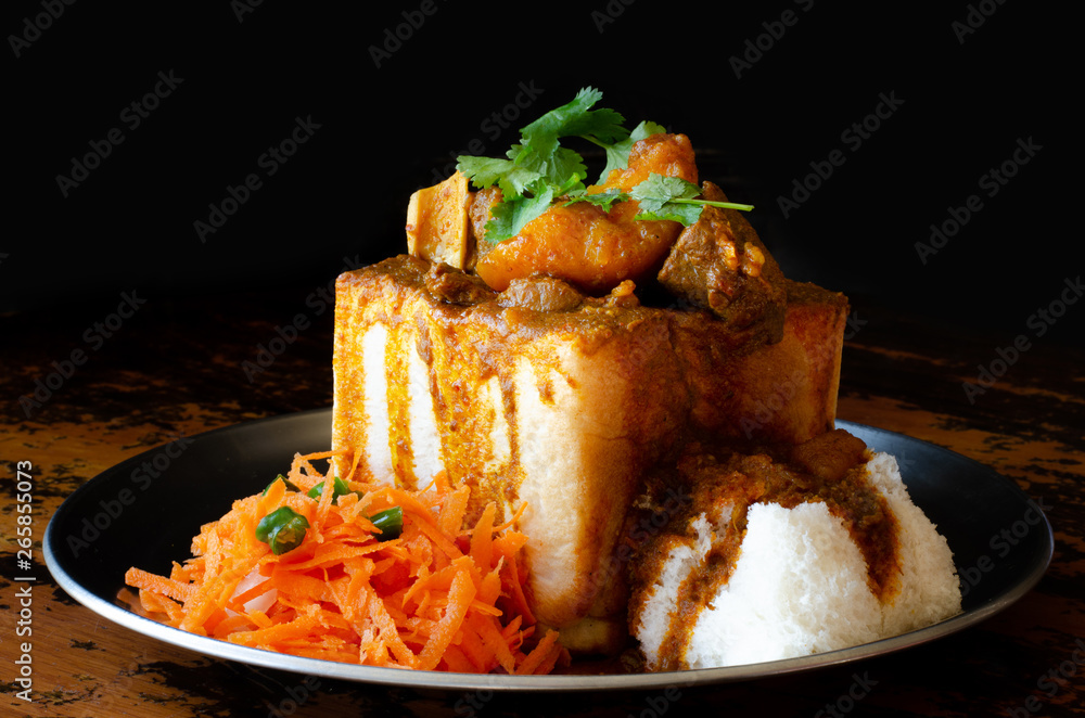 A Durban Bunny Chow - or quarter mutton bunny - served with sambals ...