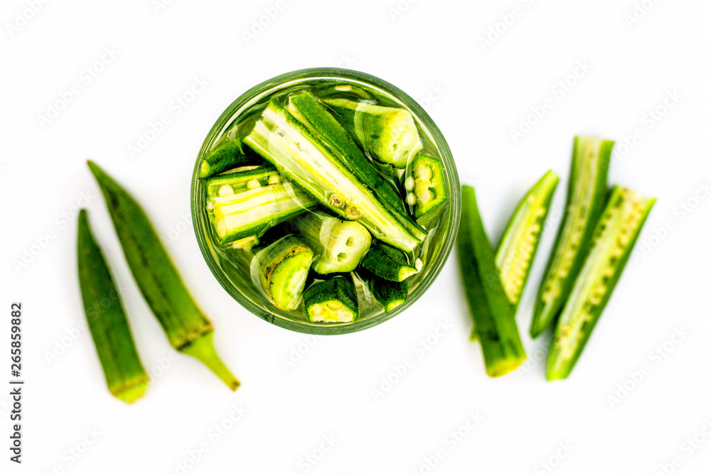 Popular Okra drink isolated on white with some okra pods in water and ...