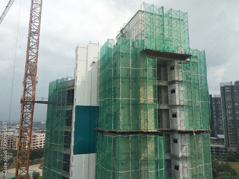 Safety netting is installed at the high rise building exterior ...