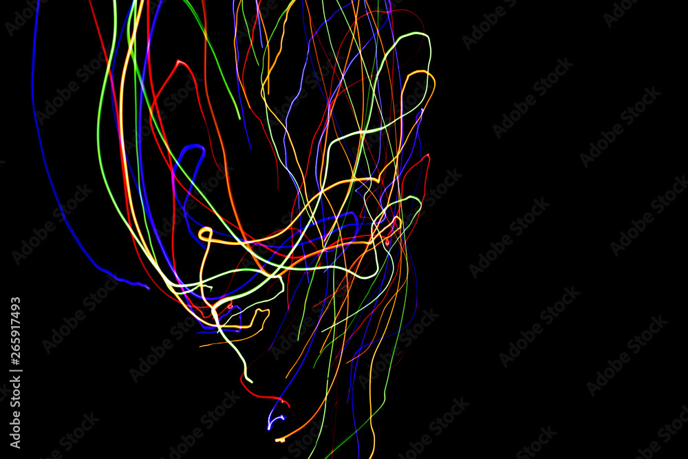 Abstract colorful lines on black background. Light painting photography ...