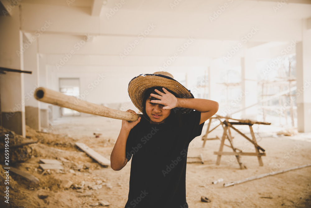 Little girl labor working in commercial building structure, World Day ...