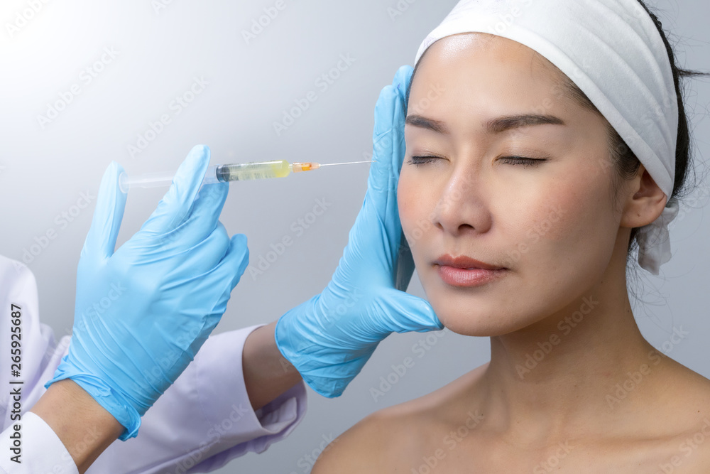 Treatment with botox concept, Asian Woman receiving Botox injection ...
