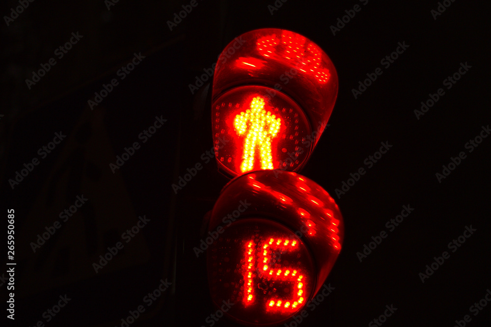 The red light of traffic light on the pedestrian crossing of a human ...