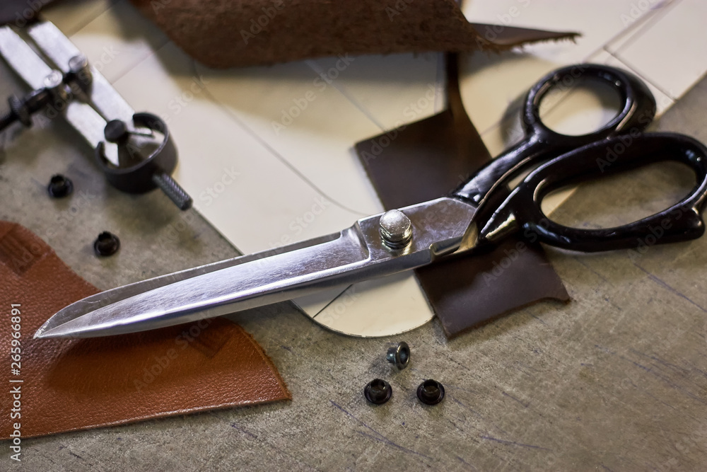 Leather crafting DIY tools and templates on workbench. Fittings and ...