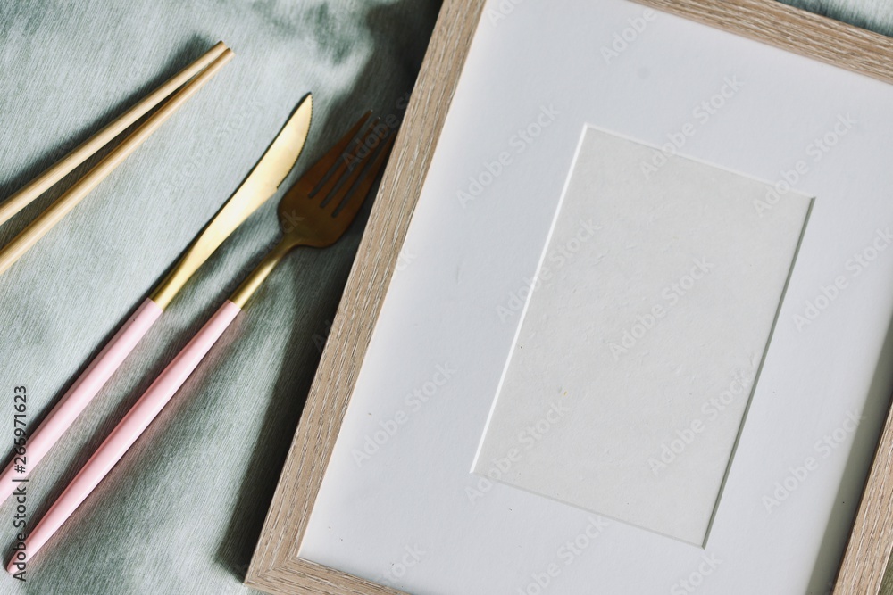 Mockup-template. Photo frame on pastel fabric. Chopsticks, fork, spoon ...
