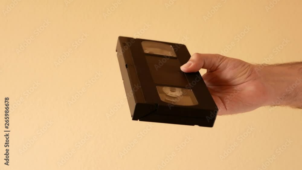 Man hand pulls out of the box a VHS video tape cassette Stock 비디오 ...
