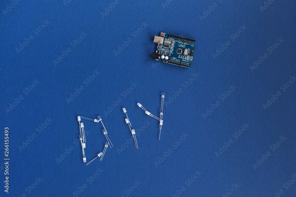 DIY word from diode and arduino uno on a blue background. arduino board ...