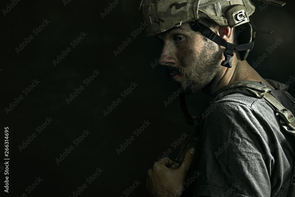 Numb to the feelings. Close up profile portrait of young male soldier ...