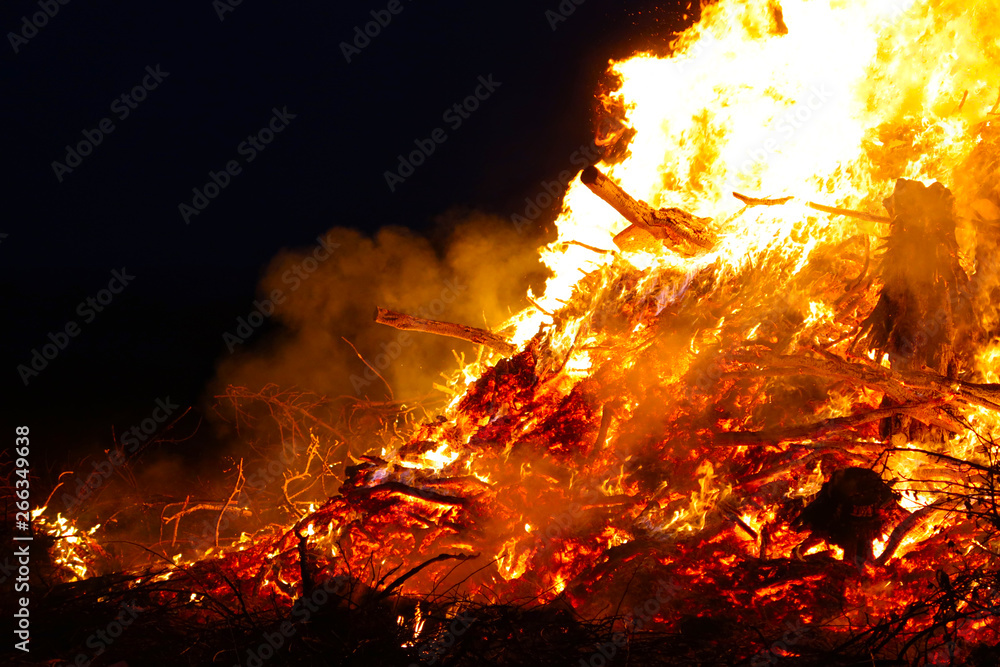 Large bonfire, burning and glowing with soft flames, sparkles flying ...