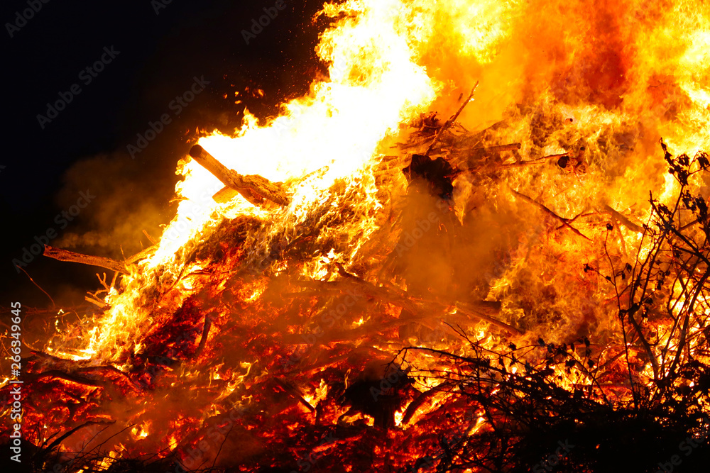 Large bonfire, burning and glowing with soft flames, sparkles flying ...