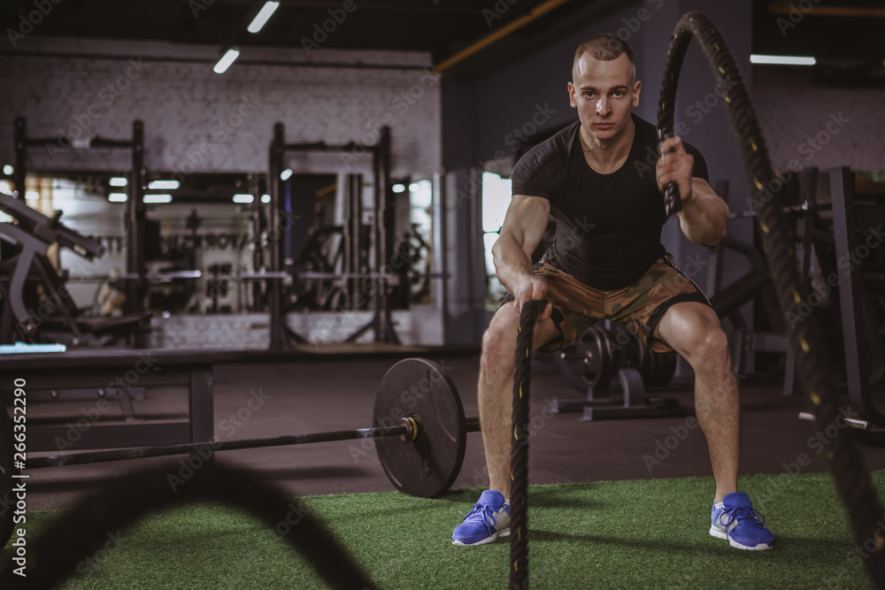 Full length shot of a male crossfit athlete having functional training ...