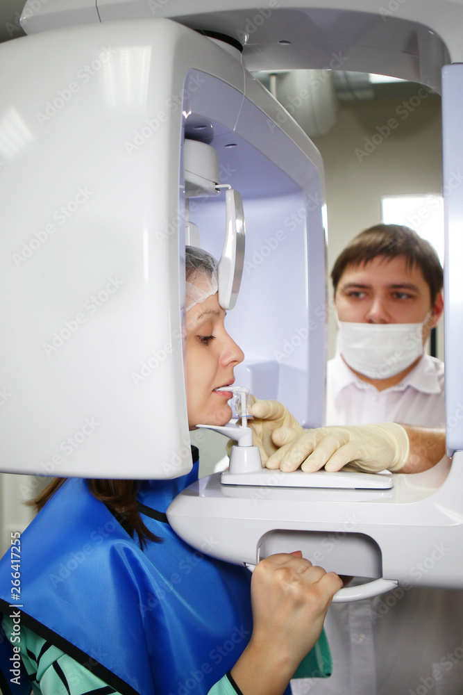 Doctor dentist and girl patient on a panorman teeth shooting. Modern ...