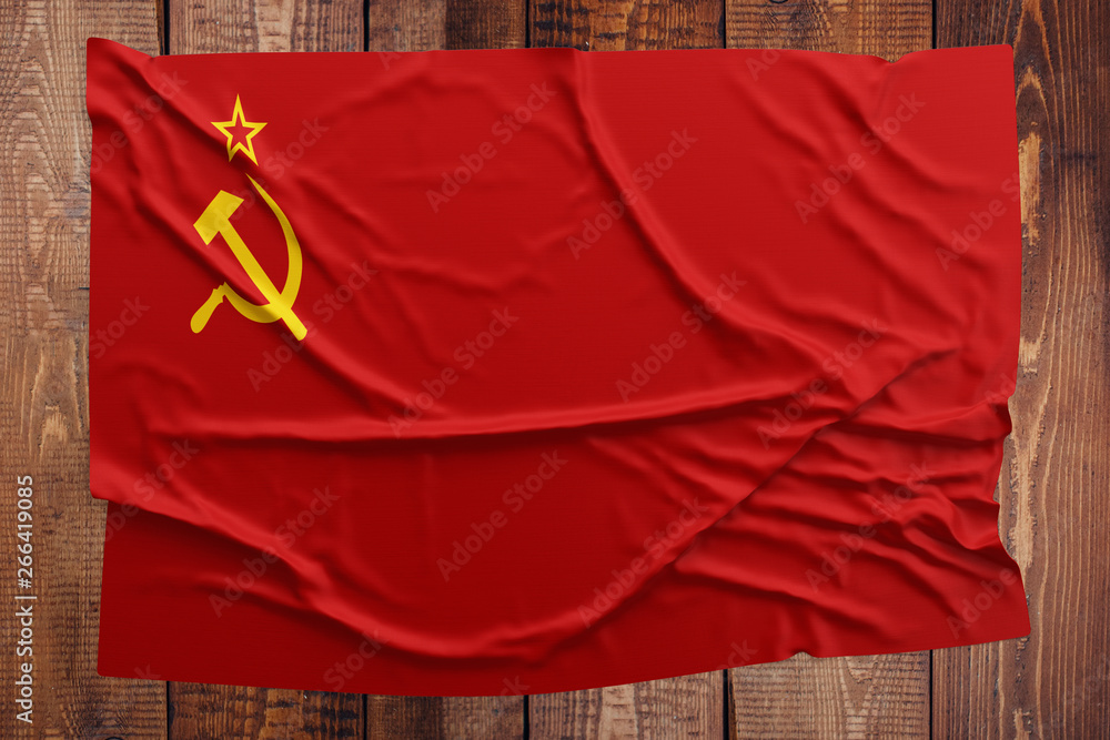 Flag of Soviet Union on a wooden table background. Wrinkled USSR flag ...
