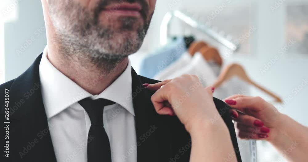 Video „Tailor using tape to measuring smiling client for sewing suit at ...