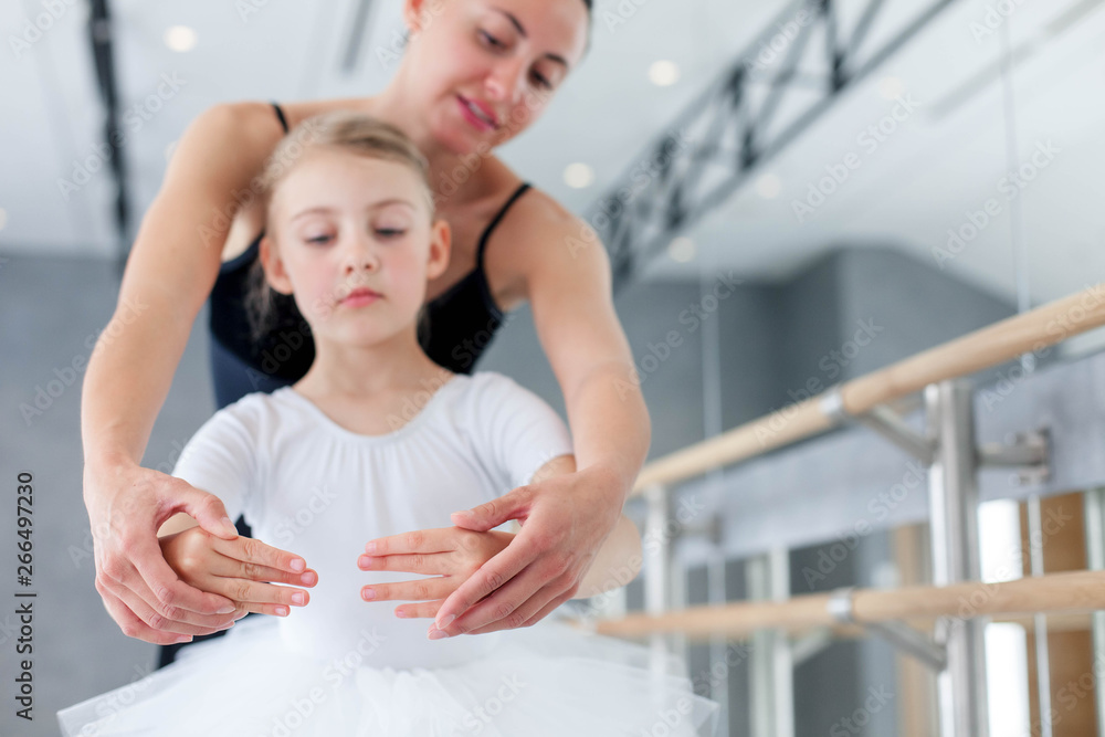 Ballet teacher and little ballerina in classical modern dancing school ...