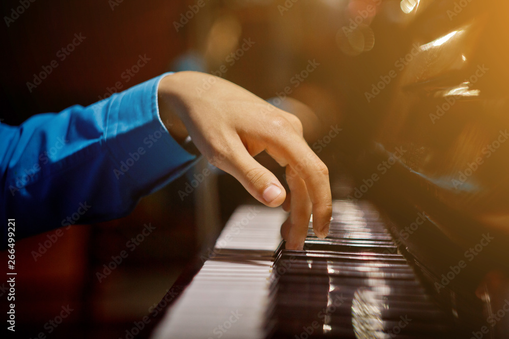 one male hand on the piano. The palm lies on the keys and plays the ...