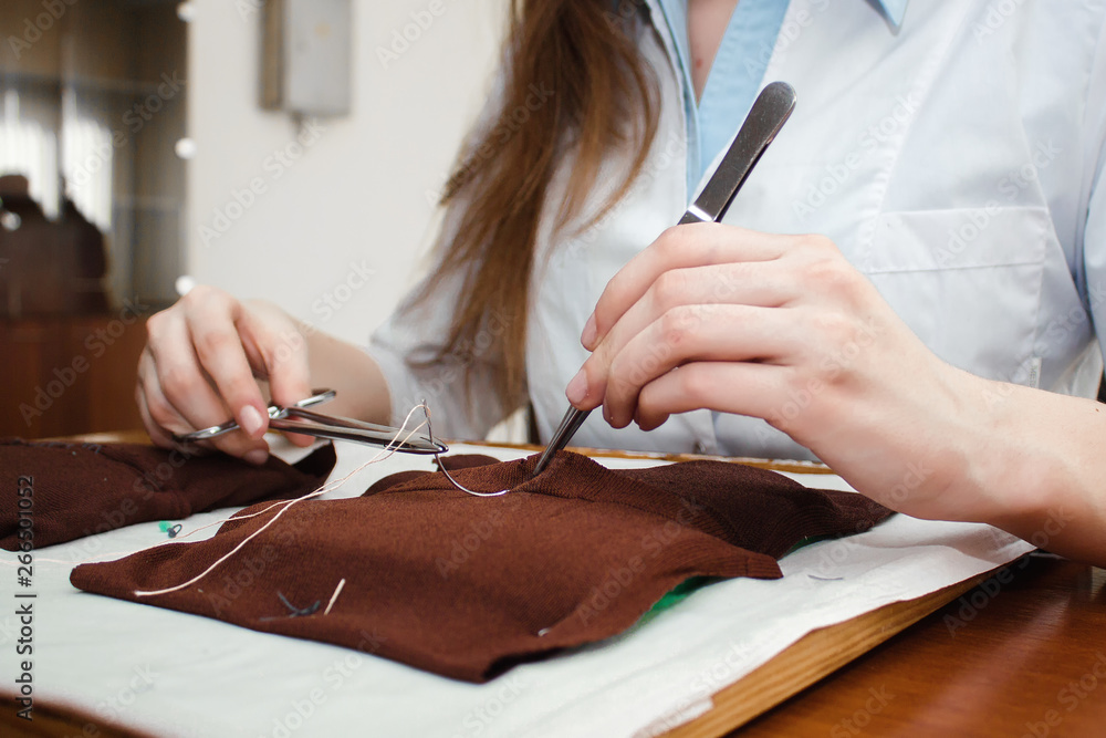 Female medical student learning stitches and suture techniques for skin ...