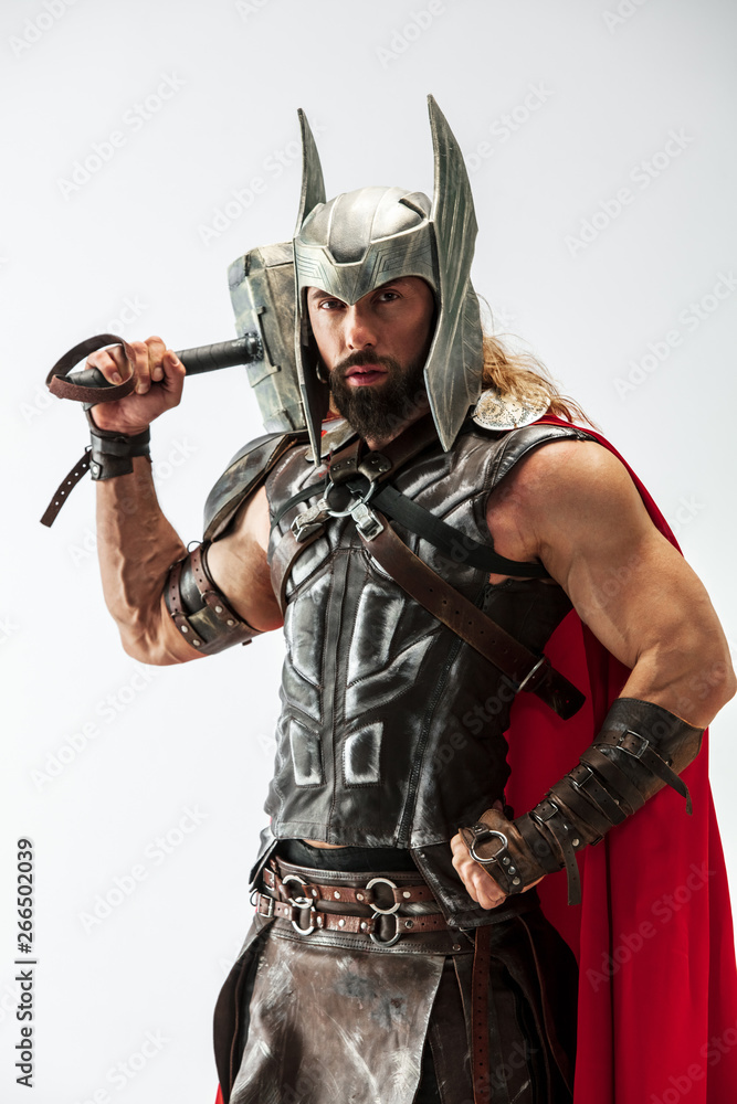 Long hair and muscular male model in leather viking's costume with the ...