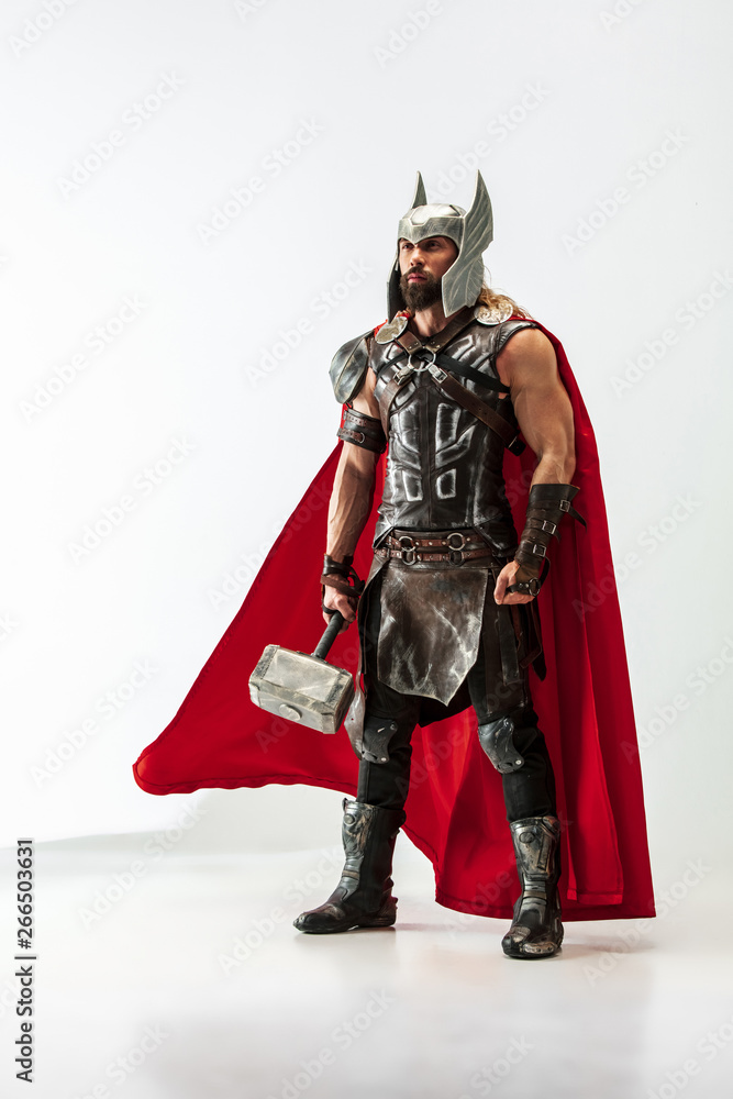 Long hair and muscular male model in leather viking's costume with the ...