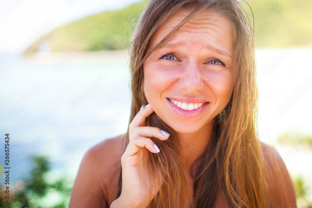 portrait face of a beautiful young girl sunbathing in the sun on the ...