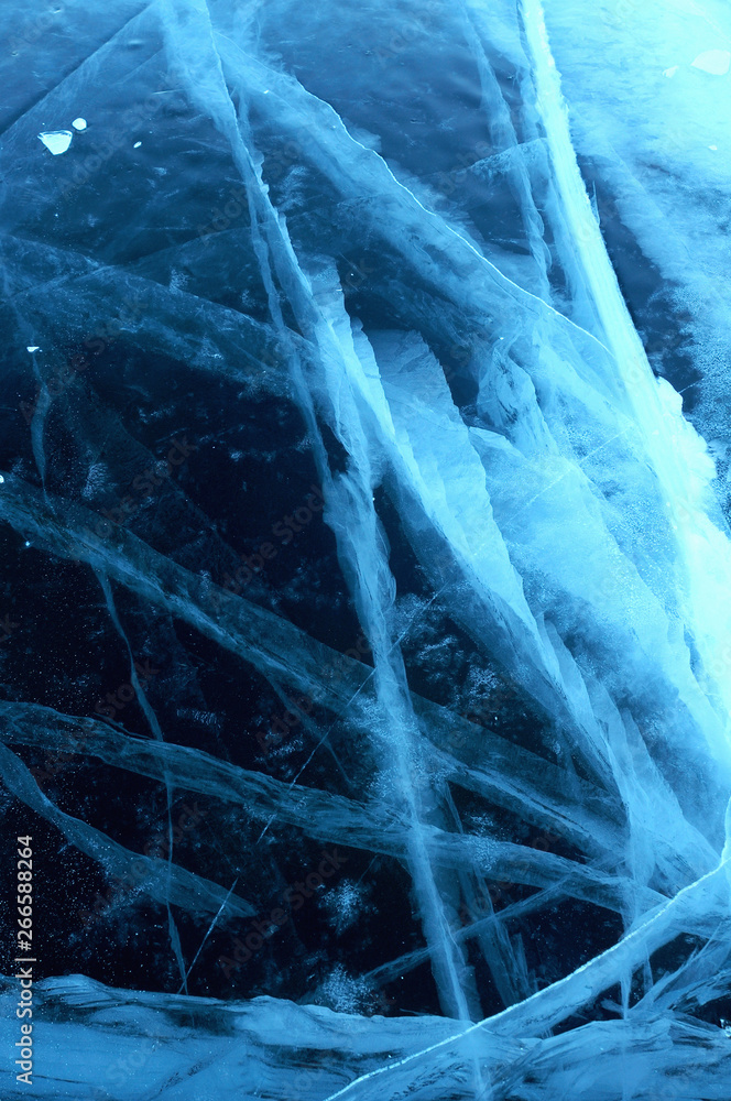 Sun rays are refracted by the transparent ice of Lake Baikal. cracks at ...