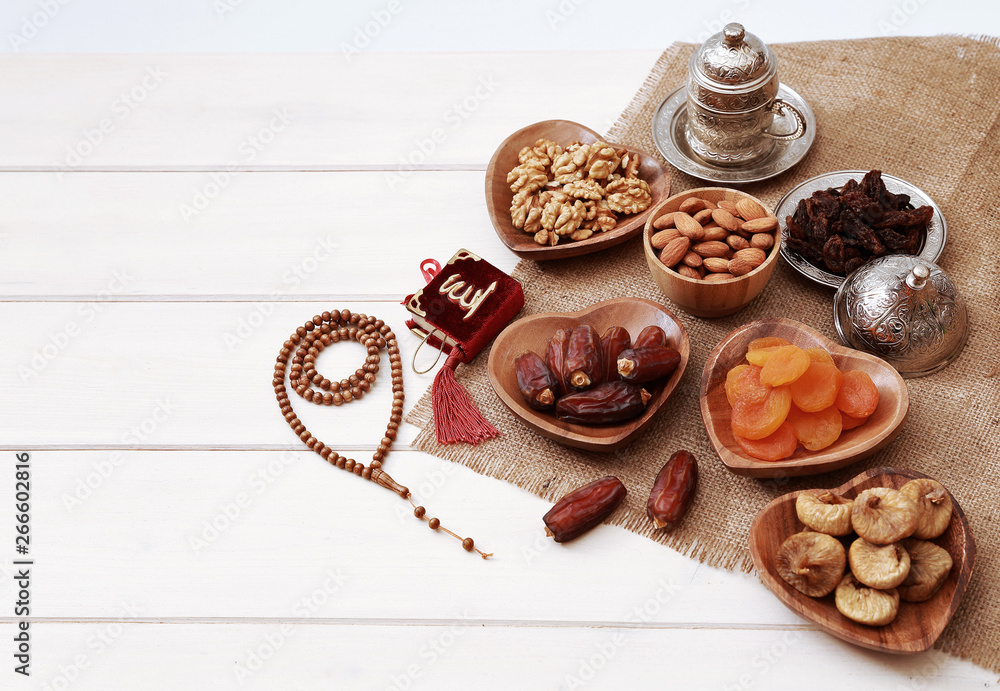 Ramadan iftar party concept. Islamic holy book Quran and rosary beads ...