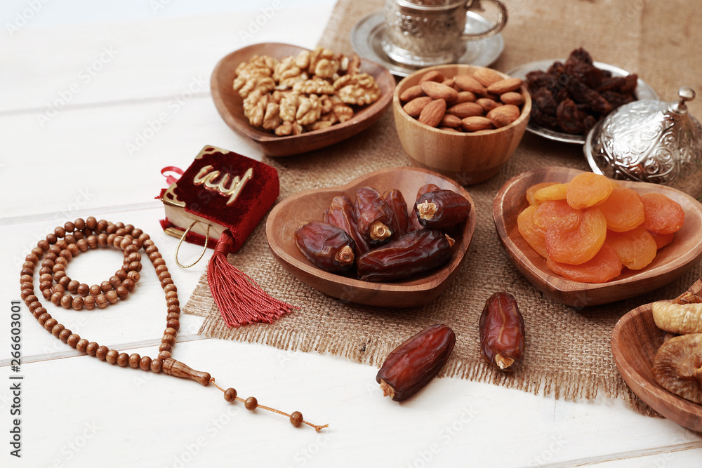 Ramadan iftar party concept. Islamic holy book Quran and rosary beads ...