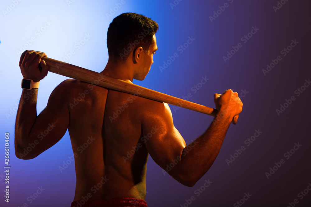 back view of shirtless sportive mixed race man with baseball bat on ...