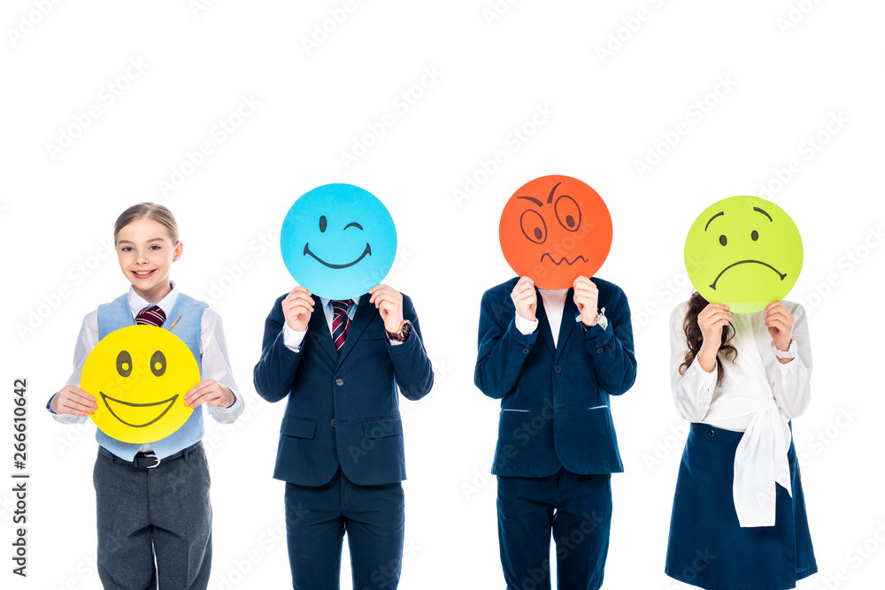 kid holding card with happy face while schoolchildren covering faces ...