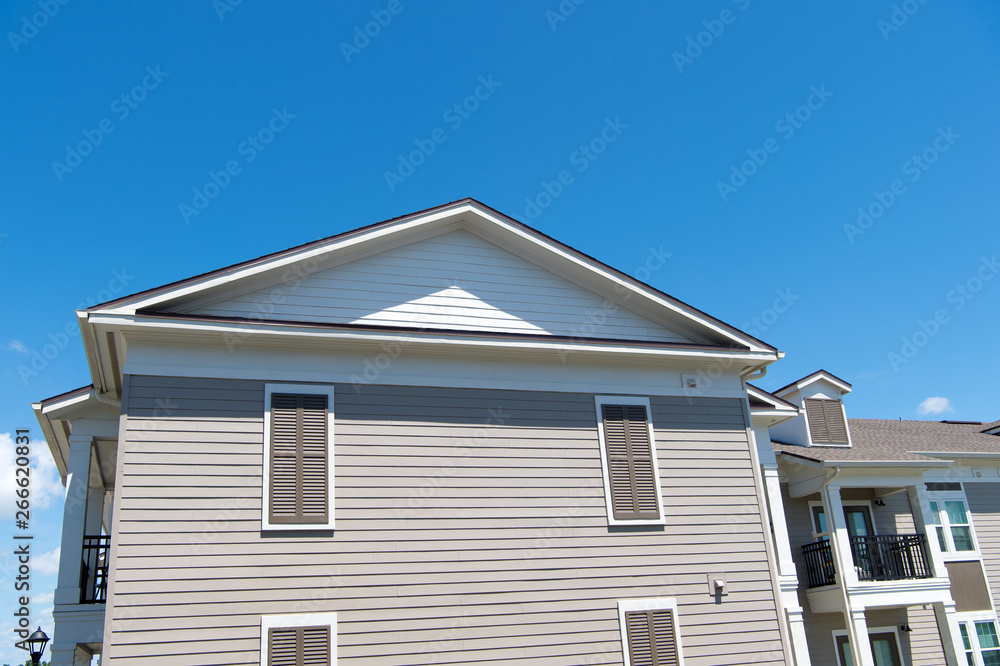 side view of house building. house roof on blue sunny sky background ...