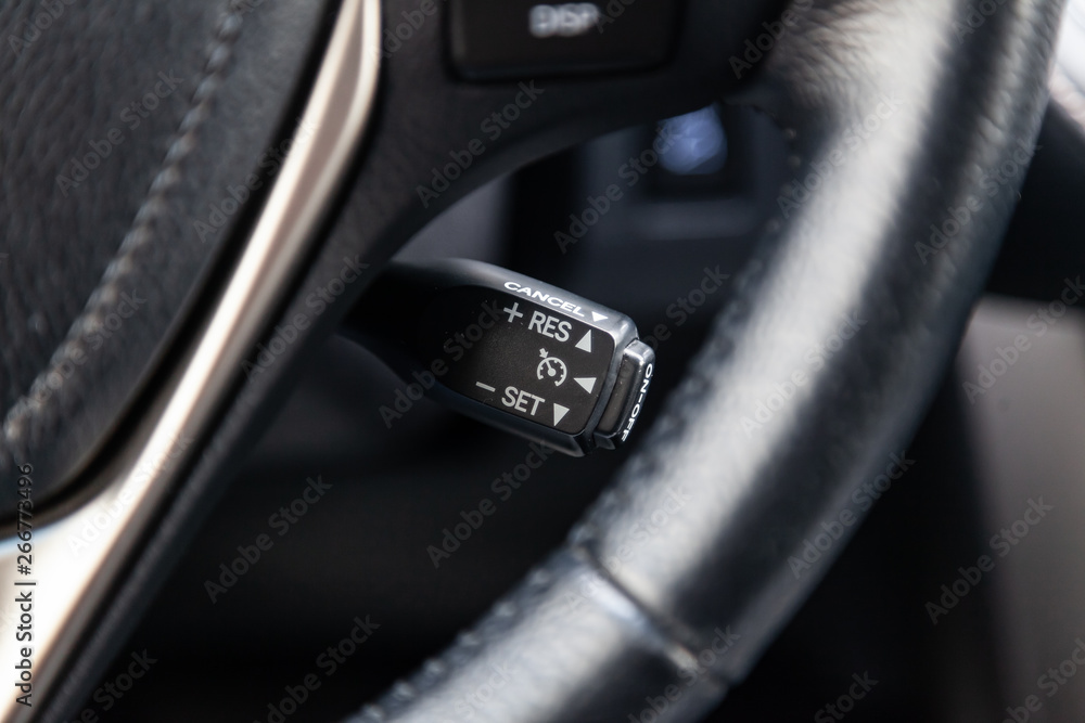 The shift lever to set the automatic cruise control speed inside the ...