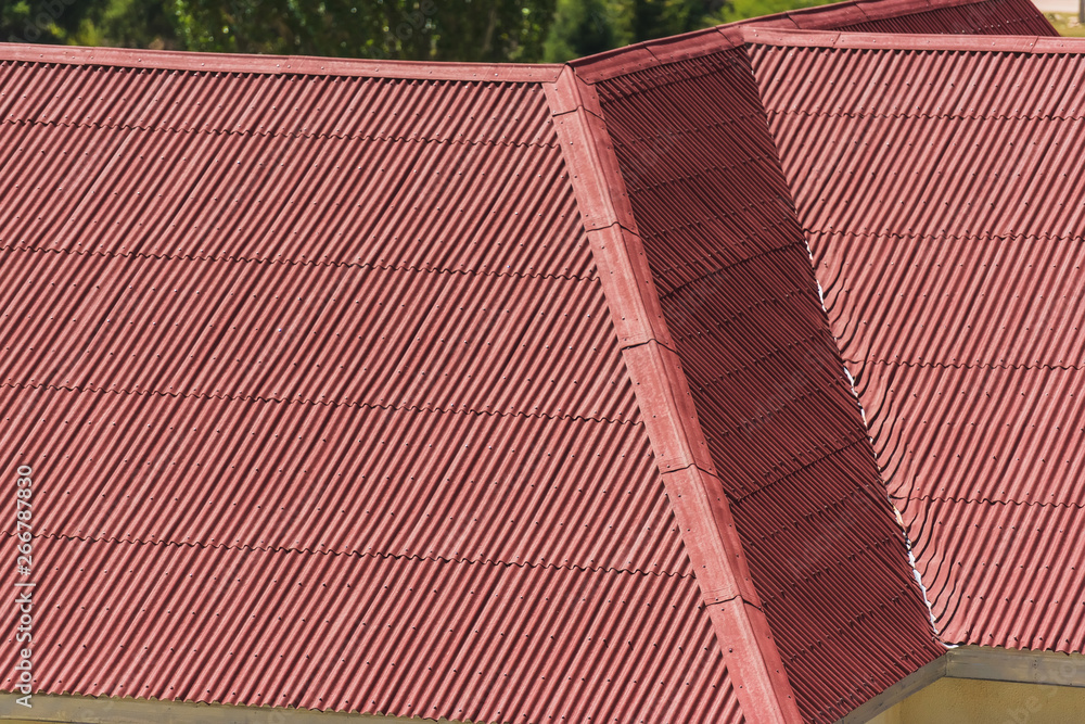 Red metal corrugated roof of the house. Rest in Kyrgyzstan. Big house ...