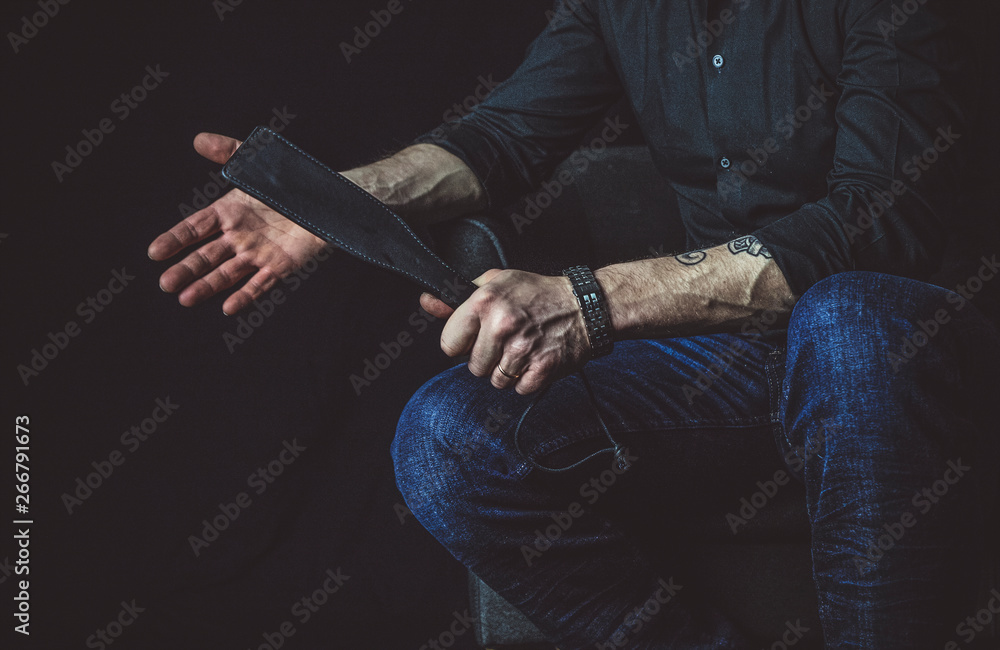 Strict man with paddle. BDSM concept. Stock Photo | Adobe Stock