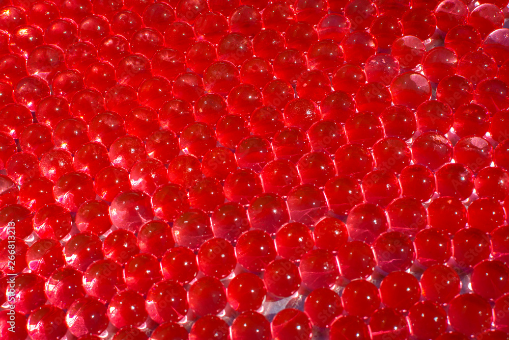 Water red gel balls with bokeh. Polymer gel. Silica gel. Balls of red ...