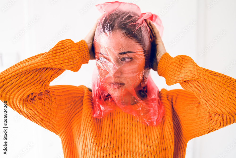 Young woman with plastic bag on her head choking, antipollution save ...