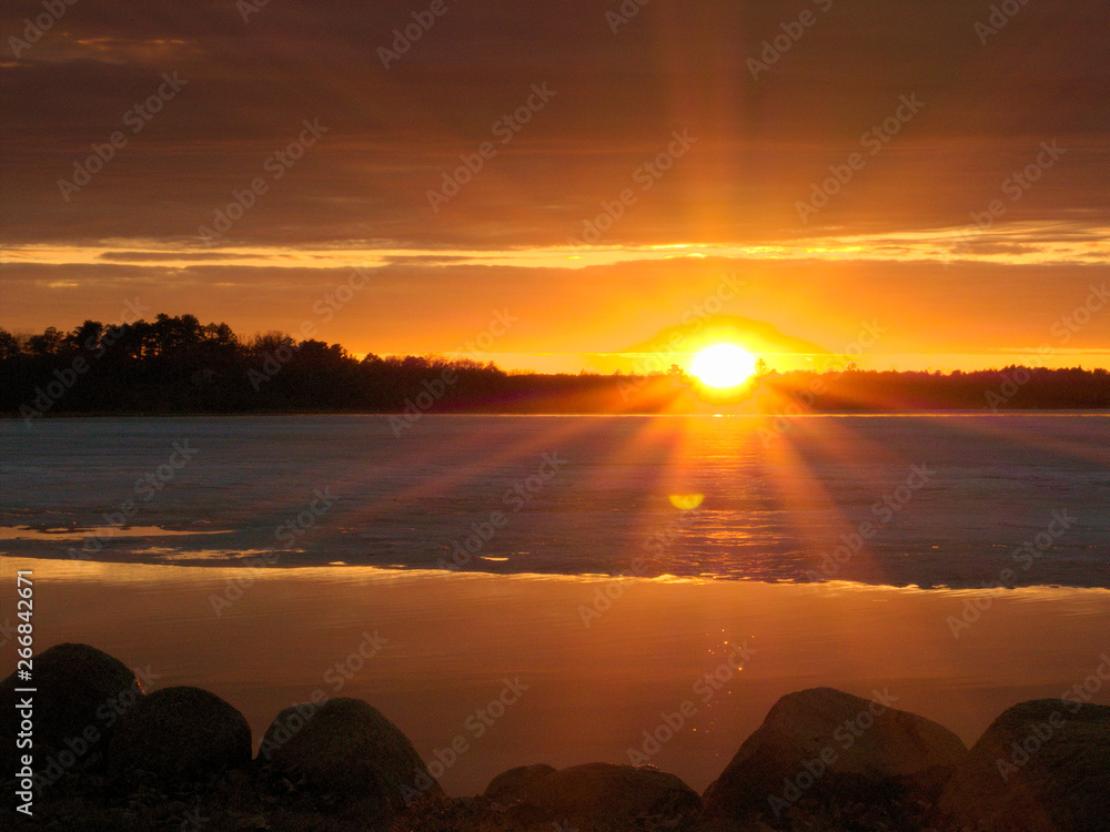 Sunset over Lake in Bemidji Minnesota that is mostly covered with ice ...