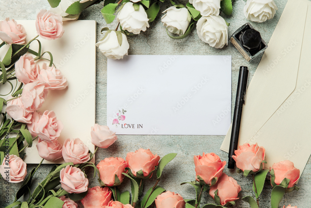 Flowers, writing paper, pens and ink on the desk Stock Photo | Adobe Stock