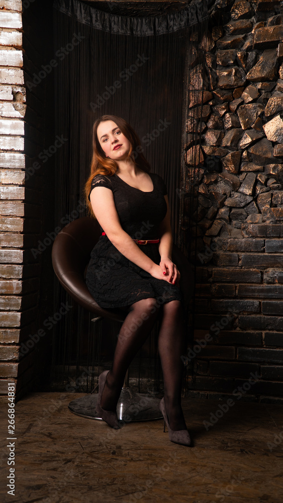 Plus size fashion model in black evening dress, fat woman on luxury ...