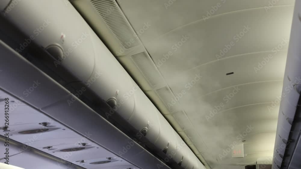 Aircraft cabin with smoke-like air vapor condensation due to ...