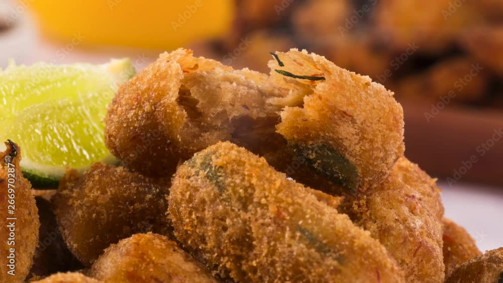 Slide shot Brazilian snack fried. Cod fish's Croquettes on the table ...